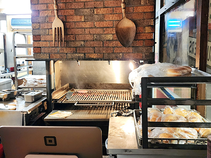 The legendary charcoal grill where burger magic happens &ndash; those grill marks aren't just for show, they're flavor geography mapping deliciousness.