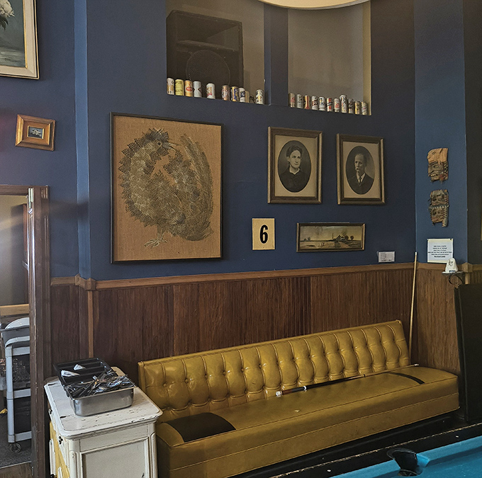 That mustard-yellow tufted bench against navy blue walls isn't just seating &ndash; it's a visual declaration that this place understands both comfort and style.