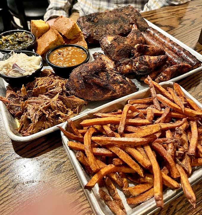 The sampler platter that launches a thousand food comas. A smokehouse symphony of pulled pork, chicken, ribs, and sides that's worth every delicious calorie.