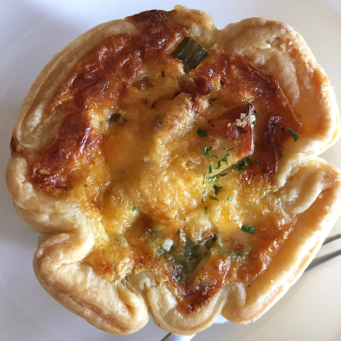 A quiche that's having an identity crisis as a work of art. That golden crust is the frame for a masterpiece of eggs and cheese.