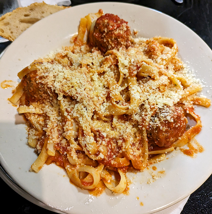 Pasta that demands respect. These fettuccine noodles swimming in marinara with perfectly formed meatballs prove that simplicity, when done right, is revolutionary.