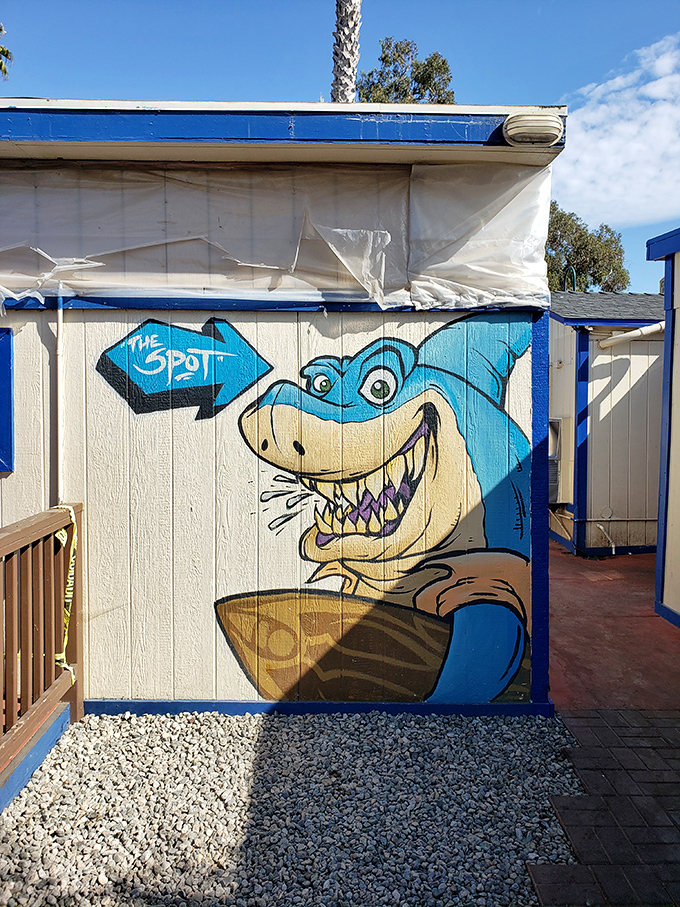 A shark with a surfboard&mdash;because California. This playful mural captures the laid-back beach vibe that makes The Spot more than just a meal.