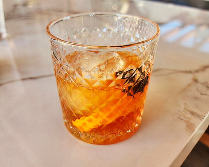 This isn't just an Old Fashioned&mdash;it's a sunset captured in crystal, with that orange peel twist adding a splash of citrus drama.