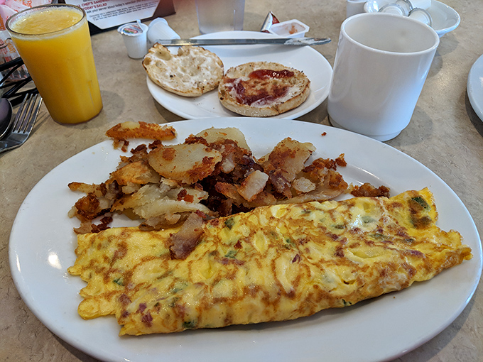 An omelet that's seen things &ndash; specifically all the delicious ingredients tucked inside it &ndash; alongside home fries that achieved the perfect crisp-tender balance.