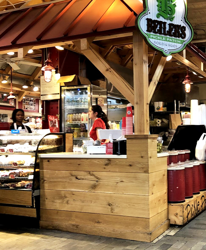 The wooden counter stands like a gateway between you and happiness, with friendly faces ready to guide you through donut paradise.