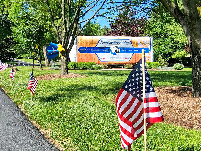 Stars, stripes, and sliced bread. Patriotic decorations complement this all-American roadside attraction, creating a quintessential slice of Midwest charm.