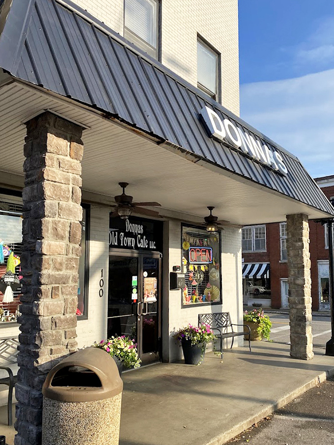 Stone columns frame the entrance like sentinels guarding culinary treasures within. The flowers add a touch of color that says, "Yes, we care about the details."