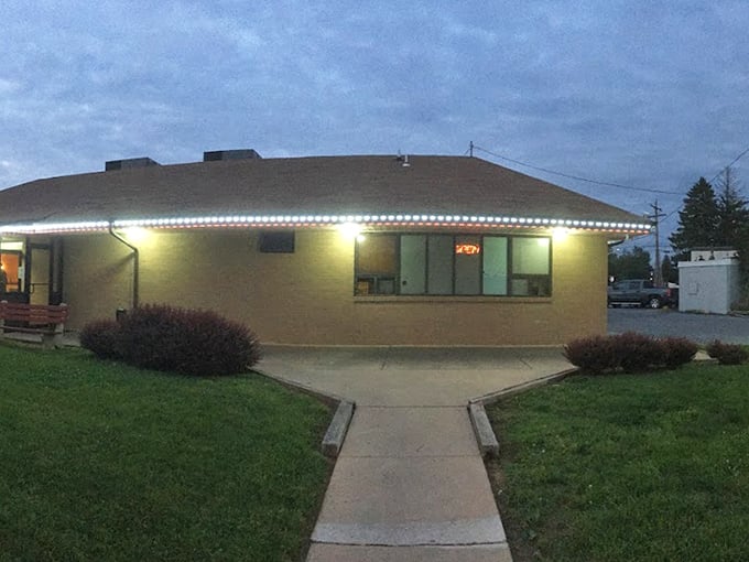 As evening falls, the diner glows with welcome. Like a lighthouse for hungry travelers, it beckons with promises of comfort food and hospitality.