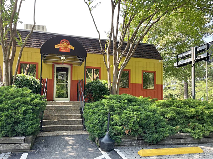 The welcoming entrance, framed by greenery, invites you into a world where smoke and sauce reign supreme.