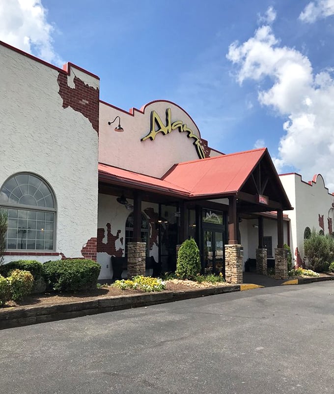 Bathed in golden sunlight, the Alamo's exterior promises a dining experience as warm and inviting as the Tennessee welcome waiting inside.