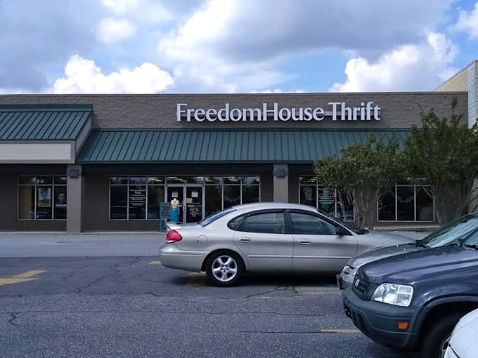 The green-trimmed exterior stands like a beacon of bargain possibilities. Each parked car represents someone inside making delightful discoveries.