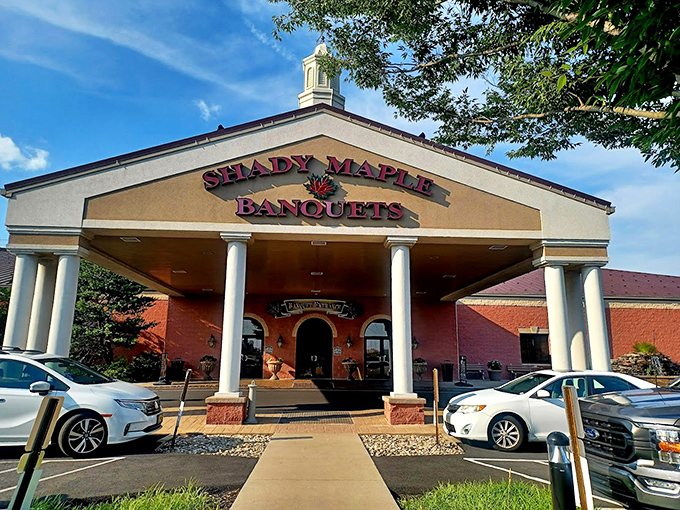 The stately columns and brick facade of Shady Maple Banquets suggest refinement, while the parking lot full of cars reveals its open secret: everybody comes here.