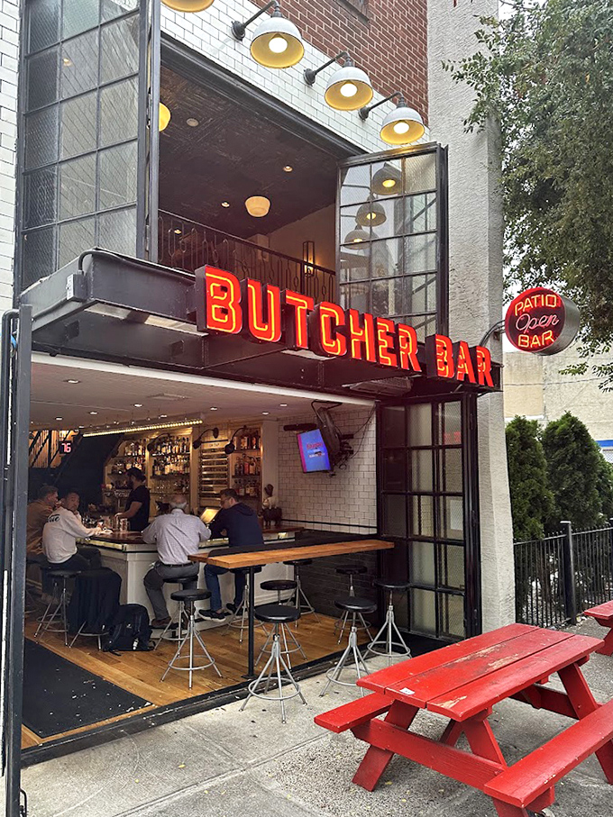 That red picnic table outside says, "Come as you are," while the neon sign above whispers, "But prepare to leave transformed."