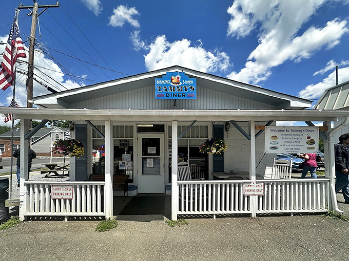 The American flag flutters beside this temple of breakfast democracy, where all are welcome to pursue happiness through hotcakes and home fries.