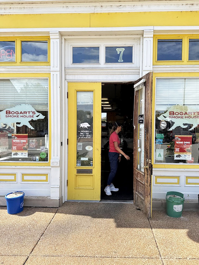 The yellow door swings open to welcome another hungry pilgrim into the temple of smoke. The journey to BBQ nirvana begins here.