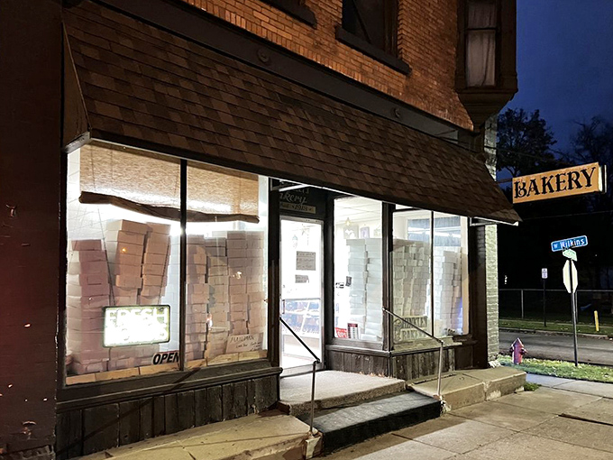 The nighttime glow promising tomorrow's fresh batch of happiness awaits behind those illuminated windows.