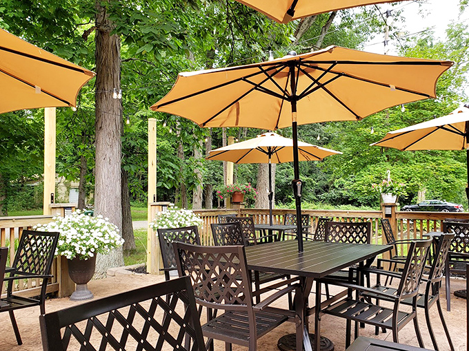 The outdoor dining area nestled among trees offers nature's ambiance with your meal&mdash;proof that sometimes the best dining room has no ceiling.