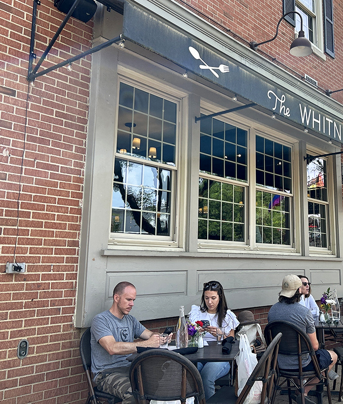 Outdoor dining at The Whitney House: where fresh air enhances flavor and people-watching becomes part of the multi-course experience.