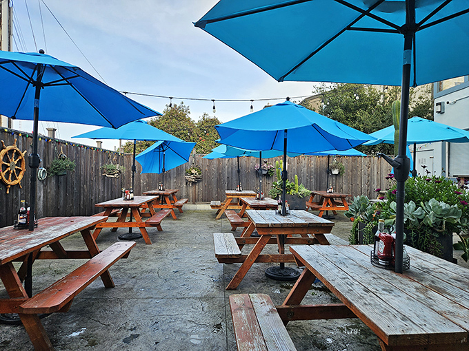 The outdoor dining area&mdash;where picnic tables and blue umbrellas create a casual backdrop for serious eating. Ocean breezes included at no extra charge.