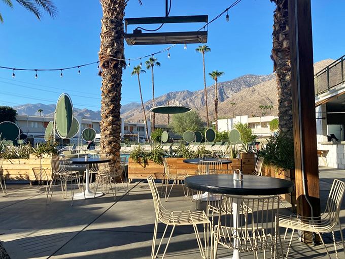 Outdoor dining with mountain views that turn every meal into an occasion, where palm trees stand sentinel over tables of happy diners.