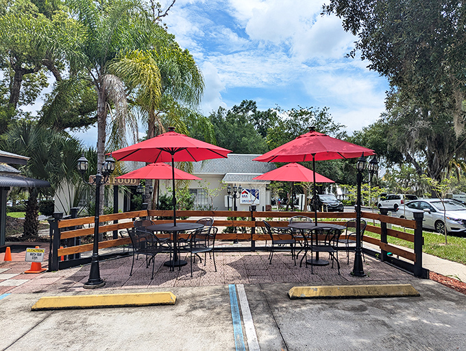 The outdoor patio with cheerful red umbrellas offers al fresco dining under Florida skies—because sometimes great seafood tastes even better with a side of sunshine.