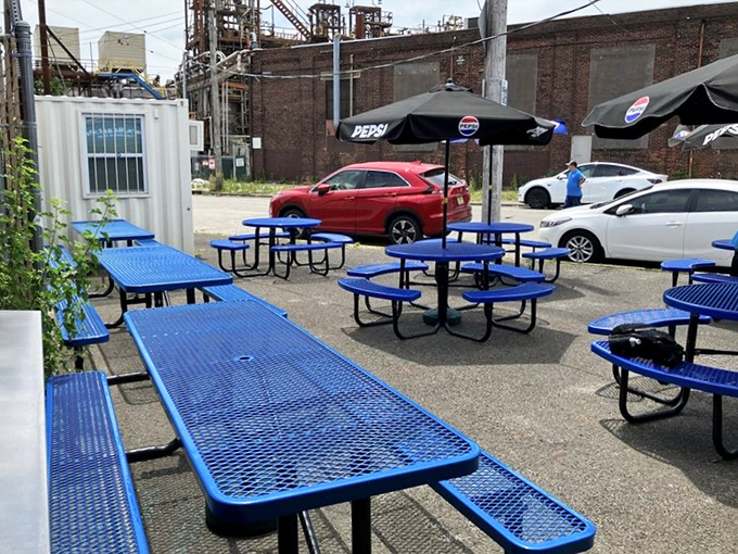 The outdoor seating area offers a moment of blue-table tranquility to contemplate the sandwich masterpiece you're about to demolish with reckless abandon.