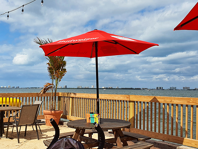 Waterfront dining with Budweiser umbrellas&mdash;because sometimes paradise doesn't need to be fancy, it just needs to be authentic and have a great view.