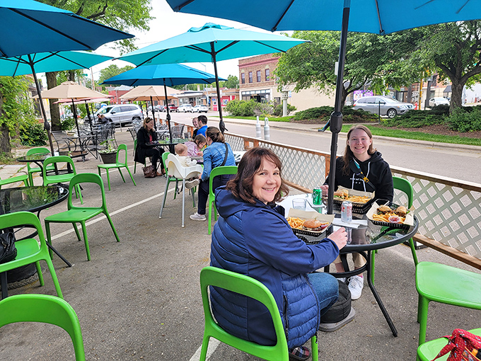 Outdoor dining that captures Madison's neighborhood charm. Blue umbrellas, green chairs, and food worth smiling about&mdash;summer in Wisconsin distilled.