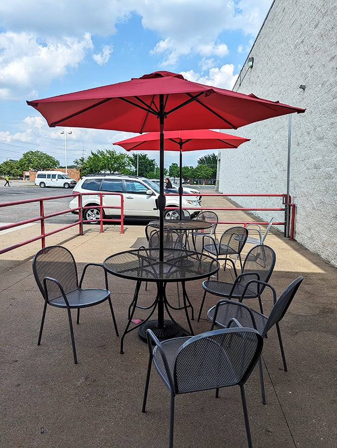The outdoor seating area, where those bright red umbrellas provide shade for conversations that inevitably circle back to "how good was that burger?"