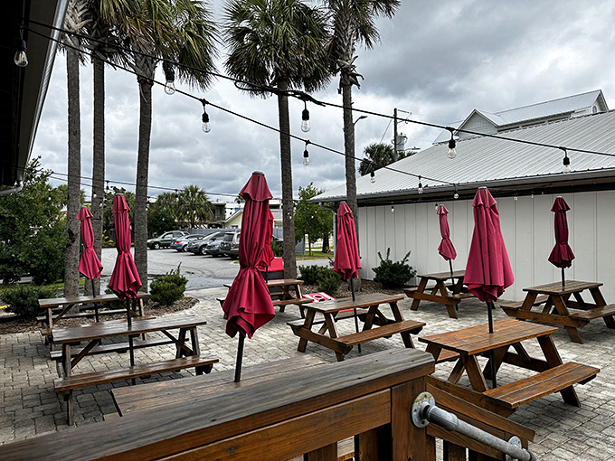 The outdoor seating area &ndash; where picnic tables under string lights and palm trees create the perfect backdrop for seafood memories in the making.