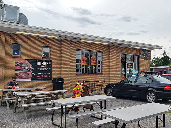 The outdoor seating area offers a no-frills dining experience where the only ambiance needed is the anticipation of the burger that's about to change your day.