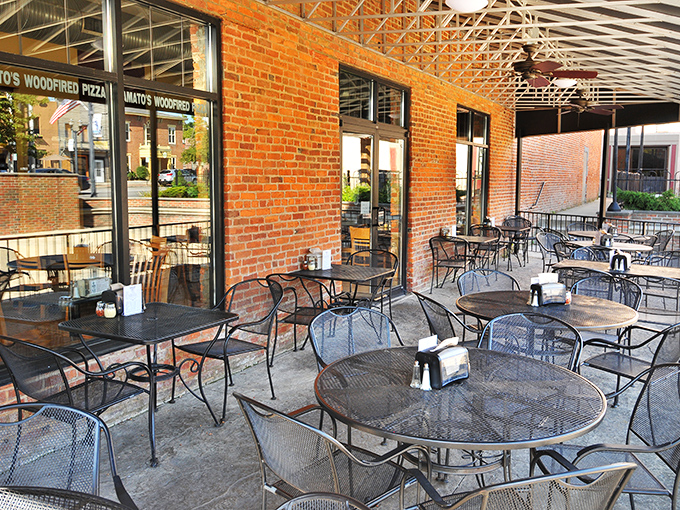 The outdoor patio at Amato's&mdash;where pizza enjoyment meets fresh air in a brick-walled urban oasis that begs you to linger just a little longer.