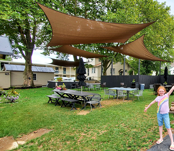 Outdoor seating under shade sails where summer breakfasts feel like mini-vacations, complete with lawn games.