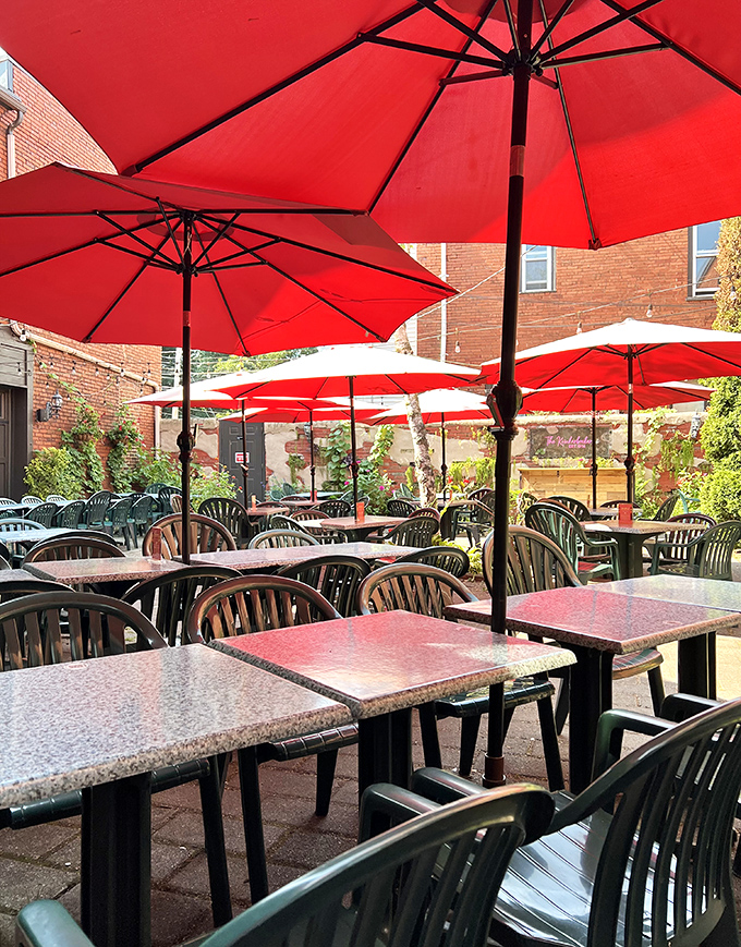 The outdoor patio's cheerful red umbrellas create an oasis where summer afternoons stretch lazily into evening, one bite of good food at a time.