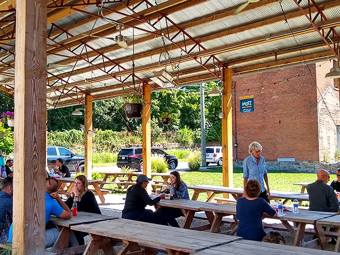 The outdoor seating area offers a communal barbecue experience where strangers become friends, united by the universal language of great food.