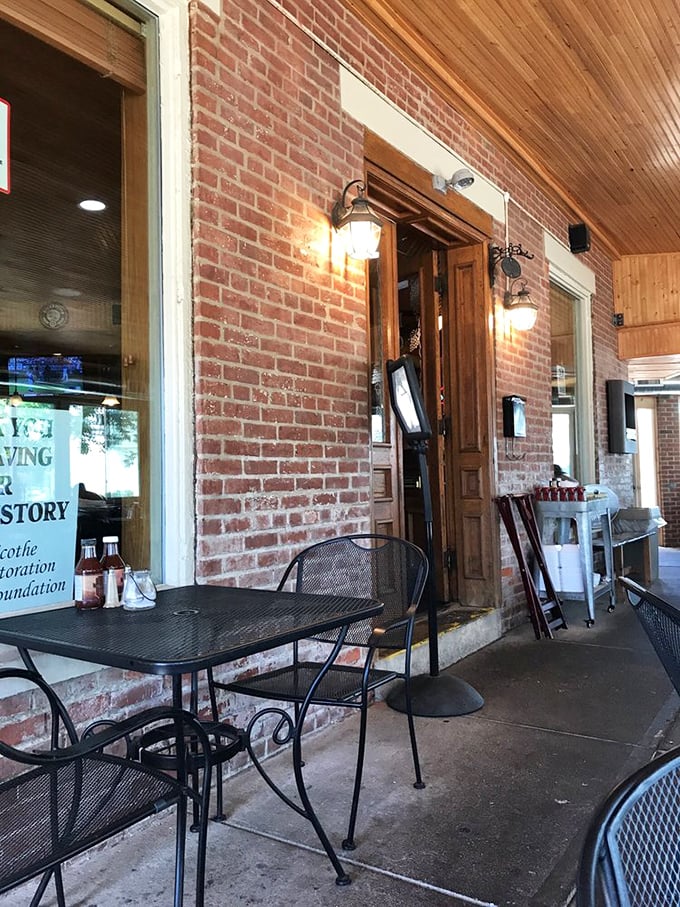 Outdoor seating offers a front-row view of Chillicothe life, where brick walls and warm lighting create an inviting atmosphere for al fresco dining.
