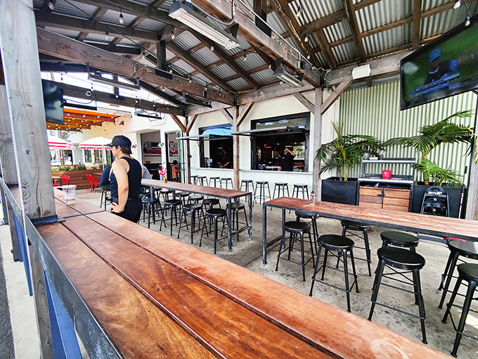 The covered patio offers al fresco dining with industrial charm. Wood, metal, and California breezes enhance the burger experience for the outdoor crowd.