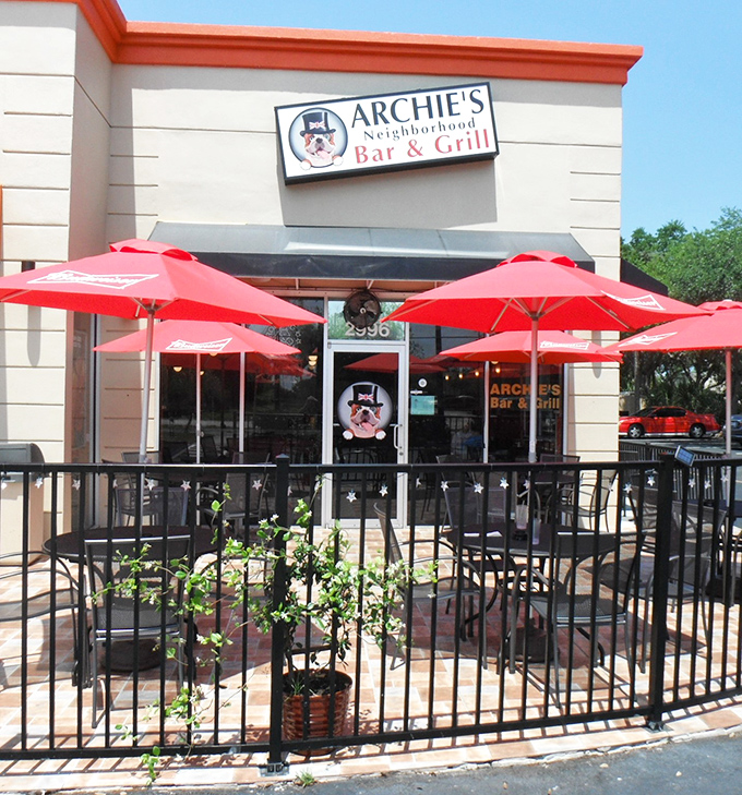 The outdoor patio offers al fresco dining under those signature red umbrellas &ndash; a proper British experience with Florida's sunshine as a bonus.