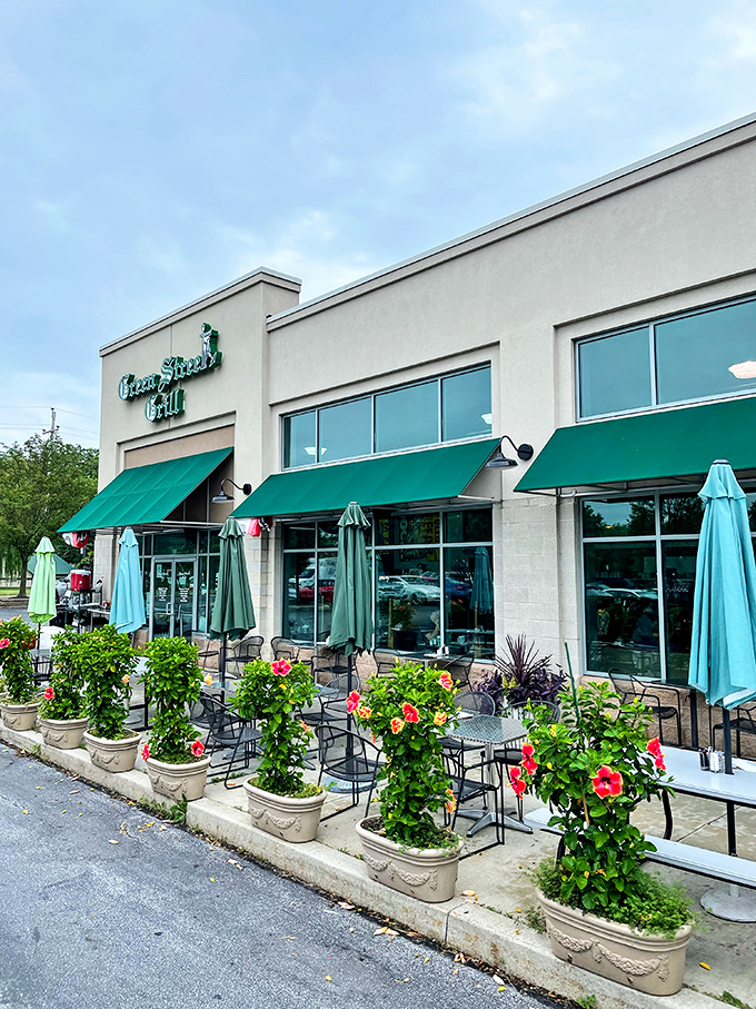 Turquoise umbrellas and blooming flowers create an inviting outdoor space that's as appealing as what's on your plate inside.