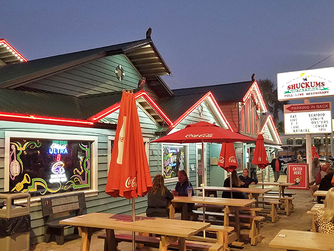 As dusk falls, the patio transforms into a coastal oasis. Those red umbrellas have witnessed more first dates and family reunions than most wedding photographers.