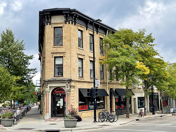 The historic building housing Tipsy Cow stands proudly on the corner. Those limestone walls have stories to tell, but they're keeping quiet about your third helping of cheese curds.