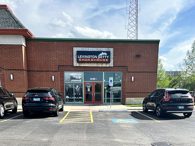The parking lot view that promises satisfaction ahead&mdash;like spotting an oasis after miles of fast-food desert. Your barbecue journey ends (and begins) here.