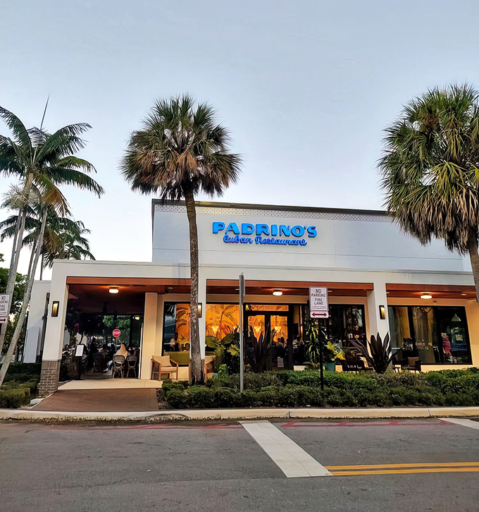 Evening transforms Padrino's exterior into a glowing beacon of Cuban cuisine—like a lighthouse guiding hungry travelers to flavorful shores.