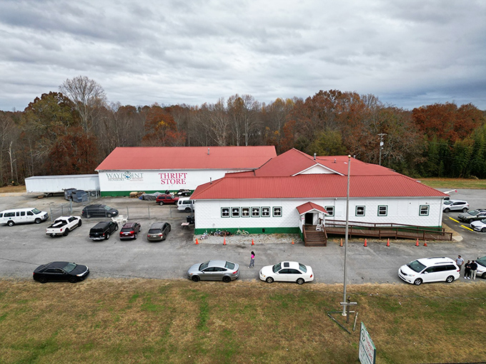 The bird's-eye view reveals Waypoint's true scale&mdash;a red-roofed bargain kingdom nestled among autumn trees. This thrift store stands as a monument to second chances.