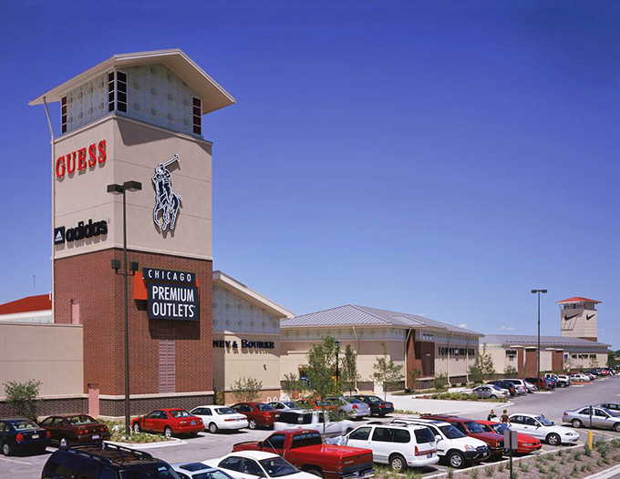 The outlet complex rises majestically against blue skies, a retail destination worthy of day-long adventures.