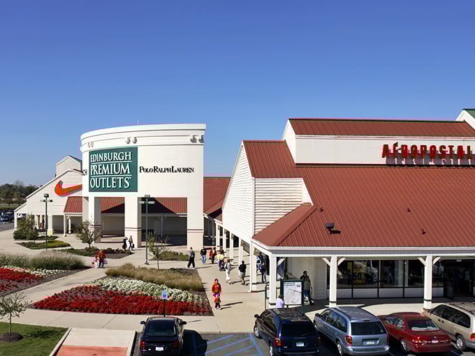 The outlet complex sprawls like a small town dedicated entirely to the noble art of bargain hunting.