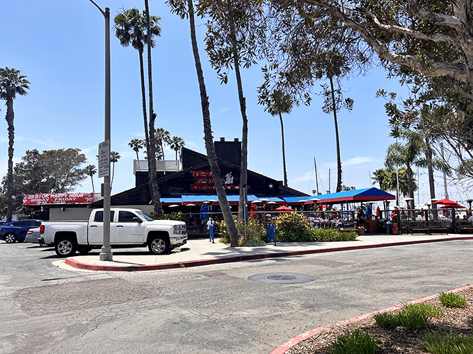 From the street, it looks unassuming, but locals know better. That black building with the red sign is where seafood dreams come true in Long Beach.