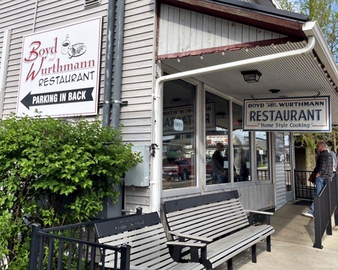 The welcoming porch with its wooden bench invites you to sit a spell, either before your meal in anticipation or after in satisfied contentment.