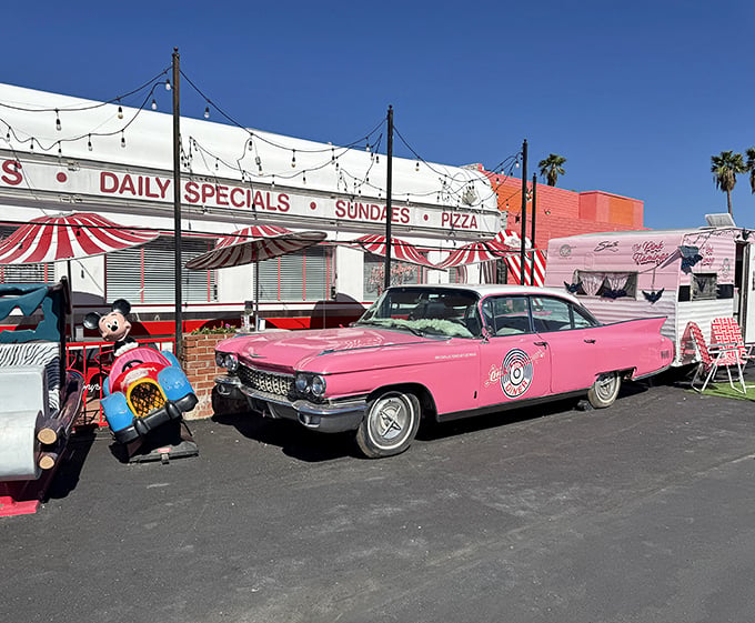 The exterior view that promises good times before you even step inside. That pink Cadillac isn't just transportation &ndash; it's a time machine.