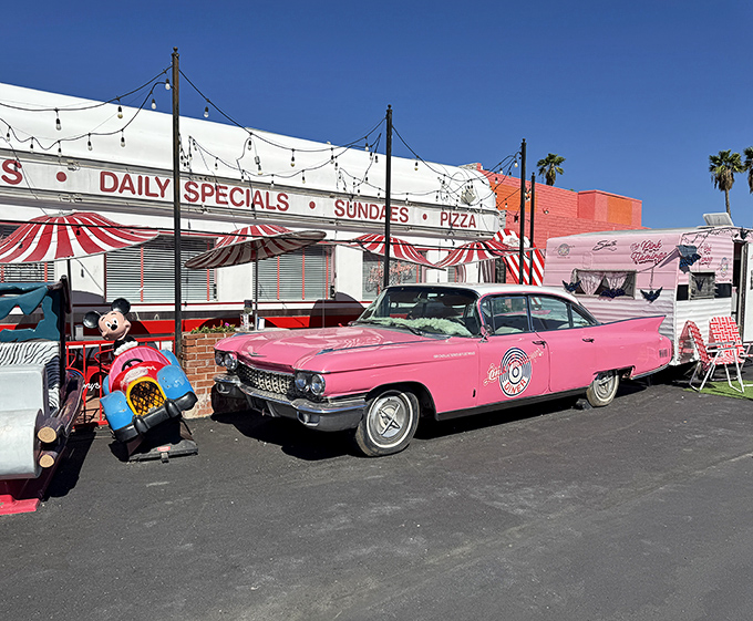 The exterior view that promises good times before you even step inside. That pink Cadillac isn't just transportation &ndash; it's a time machine.